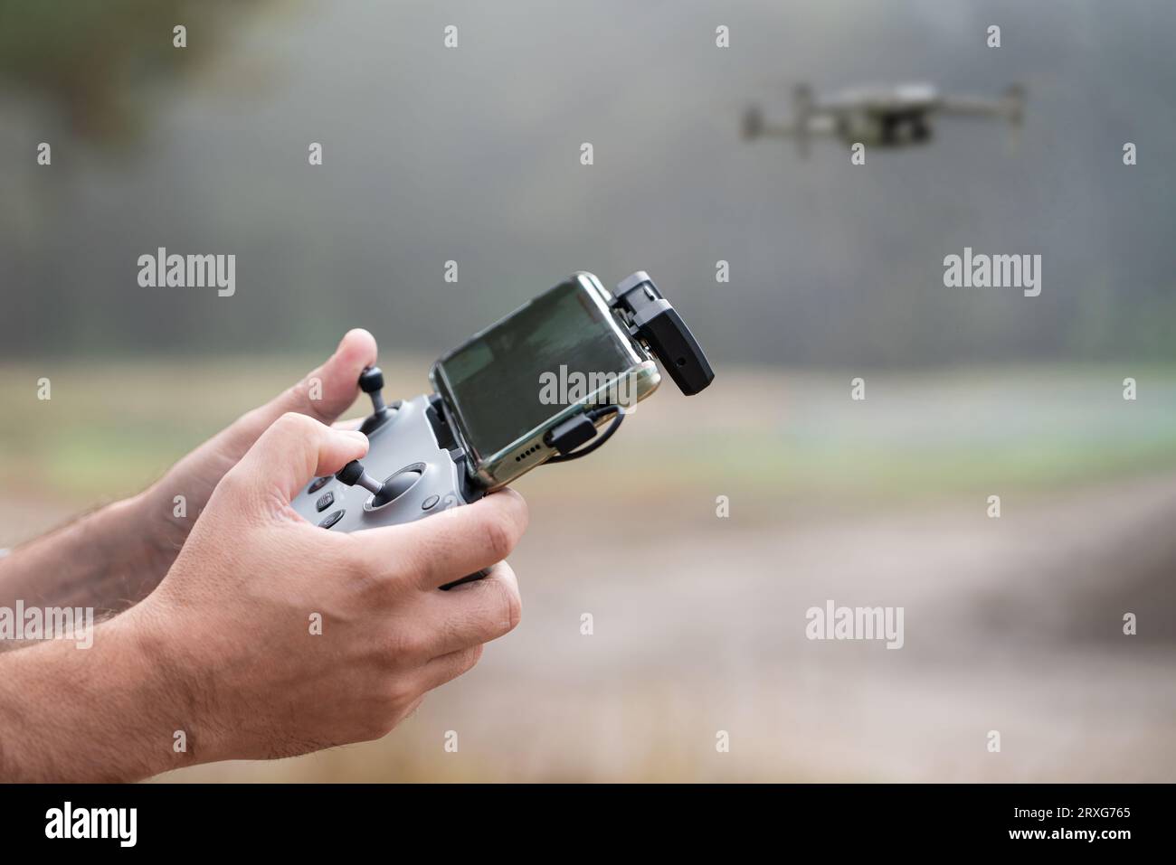 Photograph of man's hands holding the remote control of a Drone (Drone ...