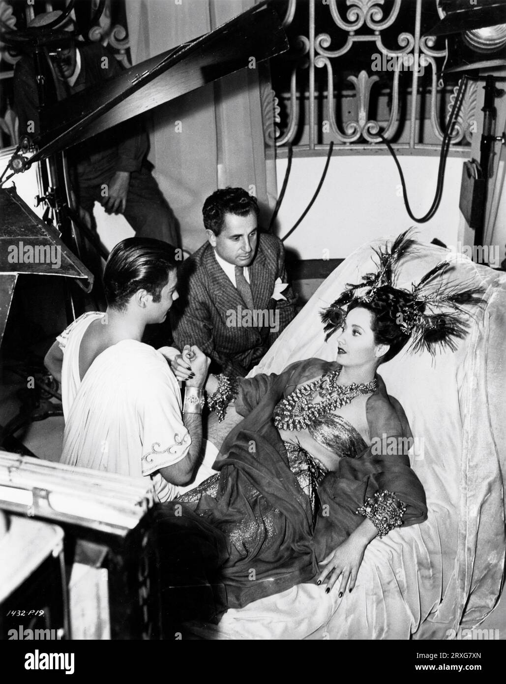TURHAN BEY Director ARTHUR LUBIN and MERLE OBERON on set candid during ...