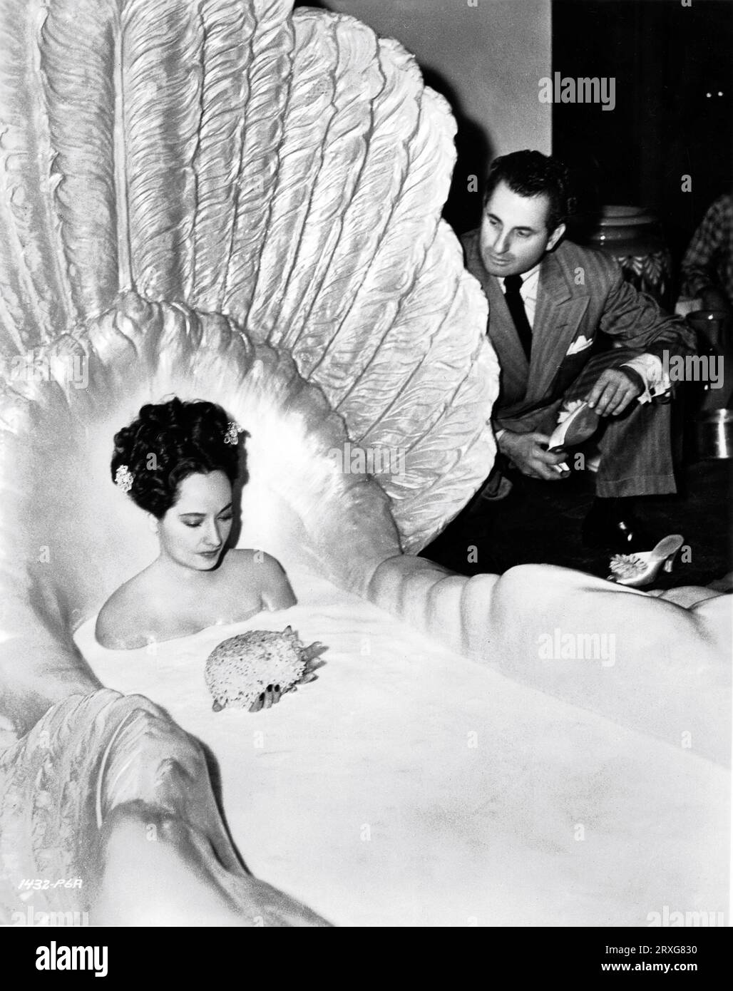 MERLE OBERON and Director ARTHUR LUBIN on set candid during filming of ...