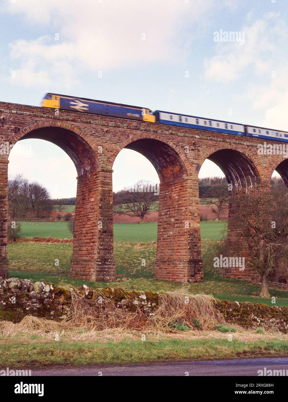 Passenger train on a viaduct Stock Photo - Alamy