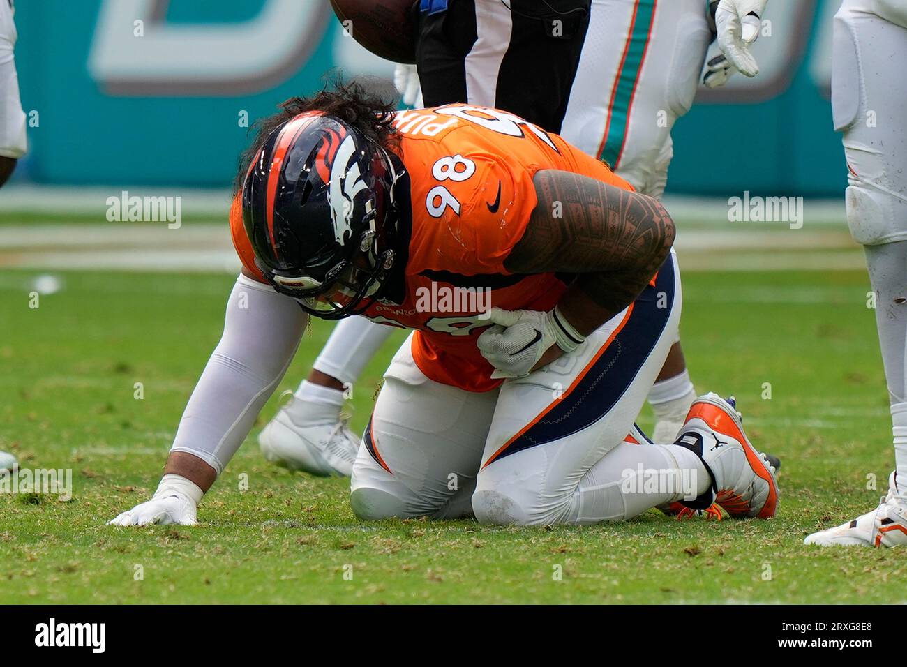 Denver Broncos defensive tackle Mike Purcell (98) lingers on the ground ...