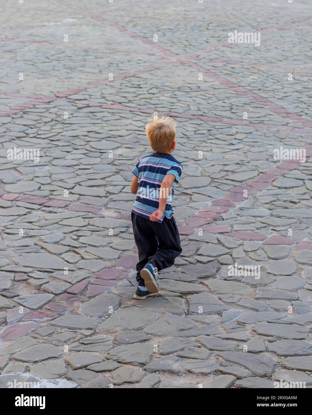Shot of the little boy running on the streets Stock Photo - Alamy