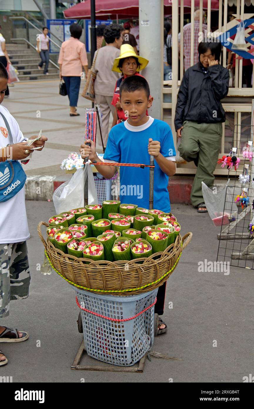 Boy selling roses wrapped in banana leaves, Chatuchak Market, Bangkok ...