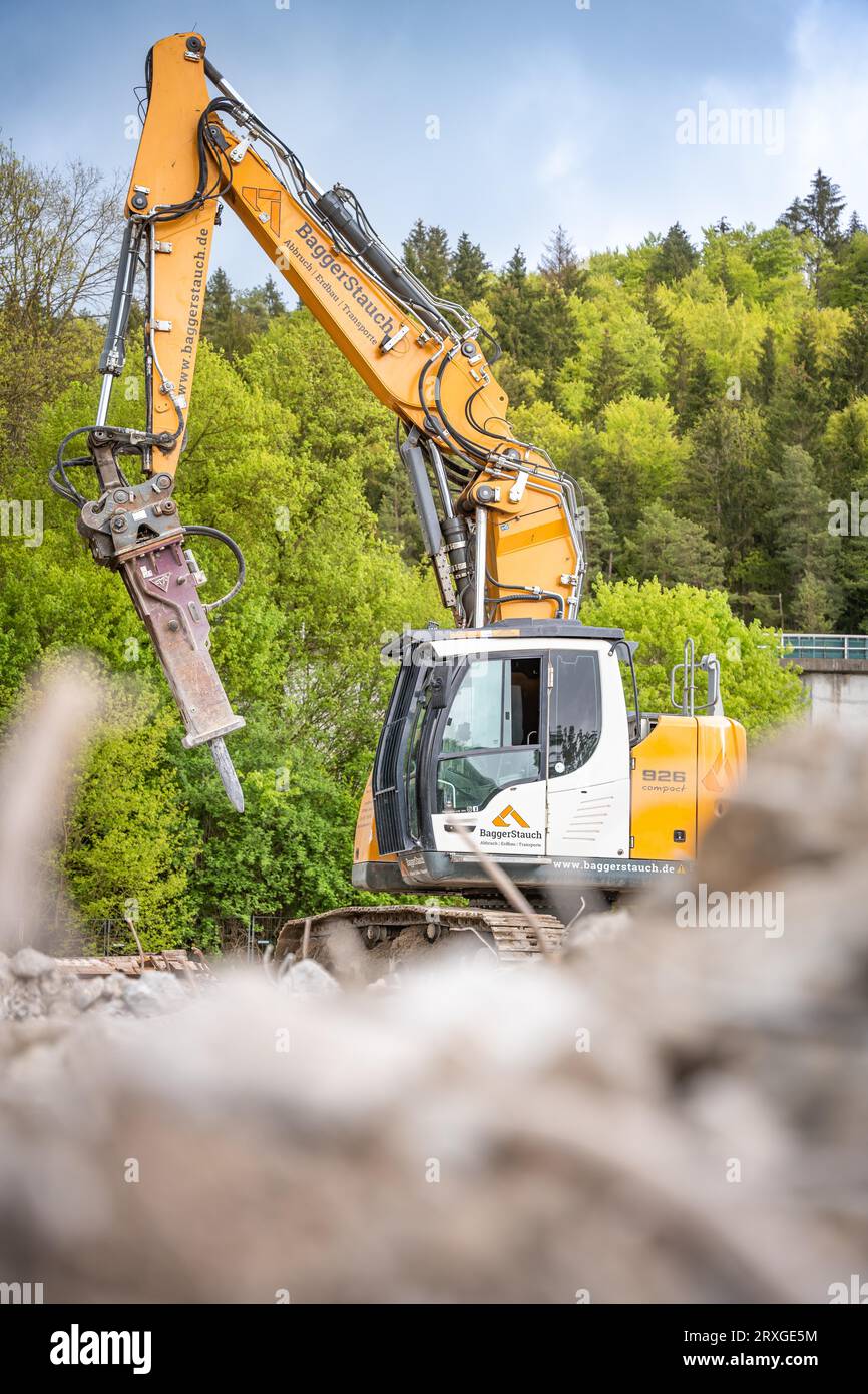 Yellow Liebherr crawler excavator with chisel recycling on demolition ...