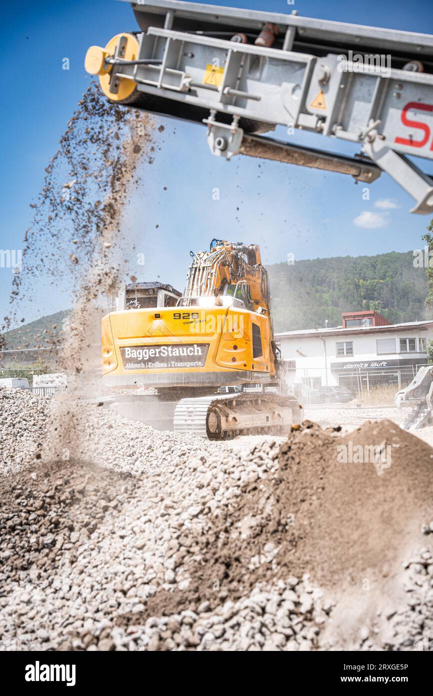Yellow Liebherr crawler excavator recycling on demolition site Stock ...