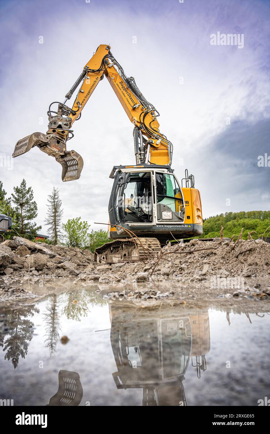 Yellow Liebherr crawler excavator recycling on demolition site Stock ...