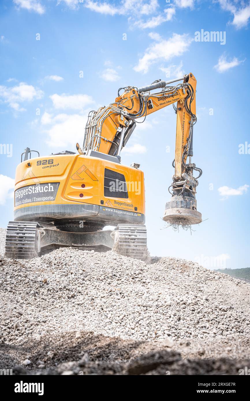 Yellow Liebherr crawler excavator with magnet recycling on demolition ...