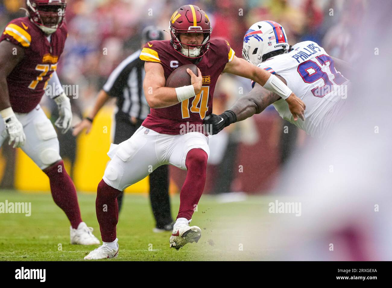 Washington Commanders quarterback Sam Howell (14) evades Buffalo Bills ...