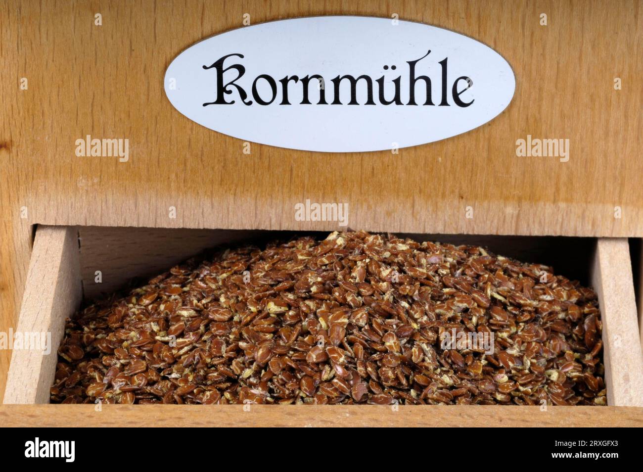 Common flax, linseed in hand mill (Linum usitatissimum), linseed in ...