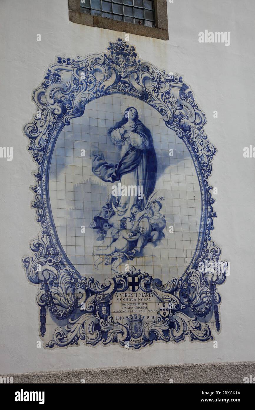 Blue tiled decoration on the exterior wall of a church in Guimaraes ...
