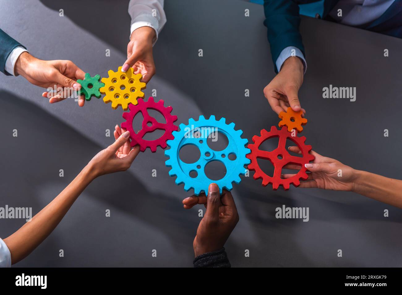 Business team work together and combine pieces of gears. Partnership ...