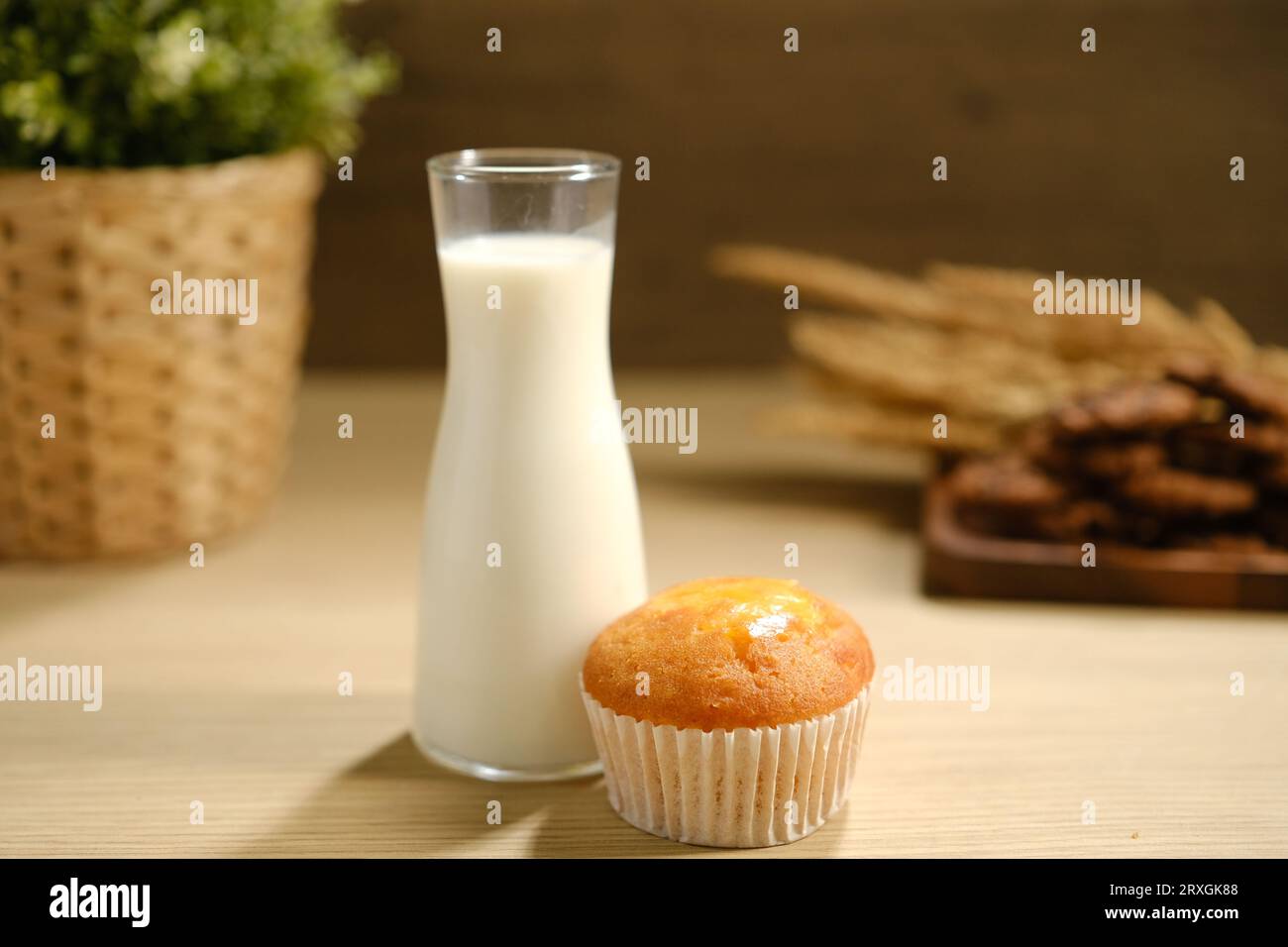 homemade muffins in white paper muffin cups and a glass of milk on the ...