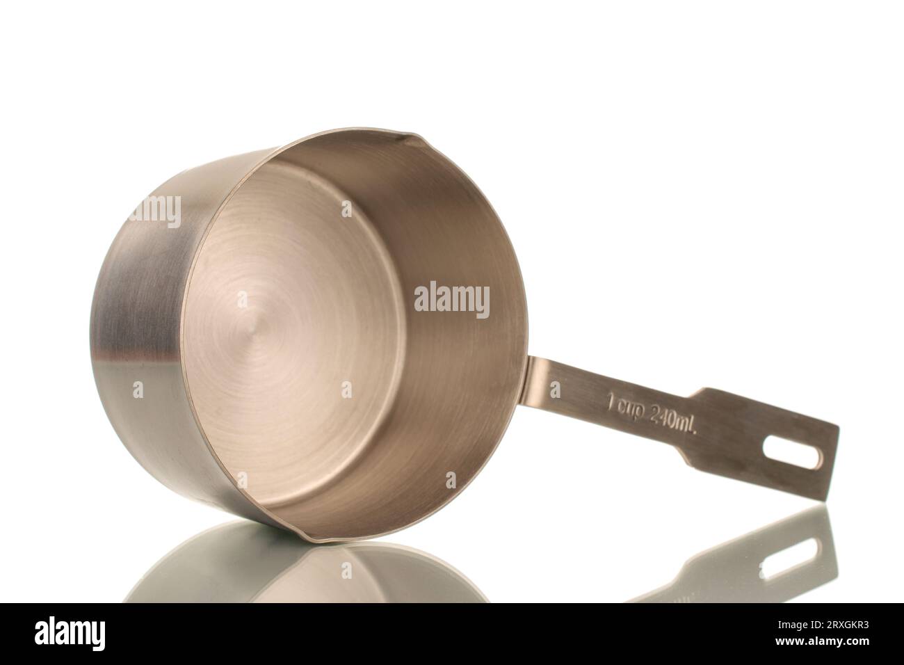 One metal measuring container for kitchen, macro, isolated on white ...