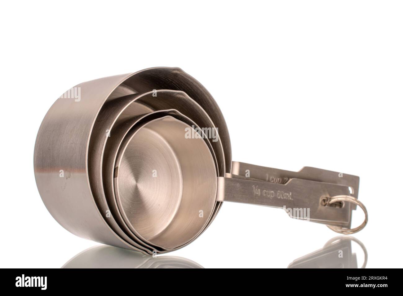 Four metal measuring containers for kitchen, macro, isolated on white ...