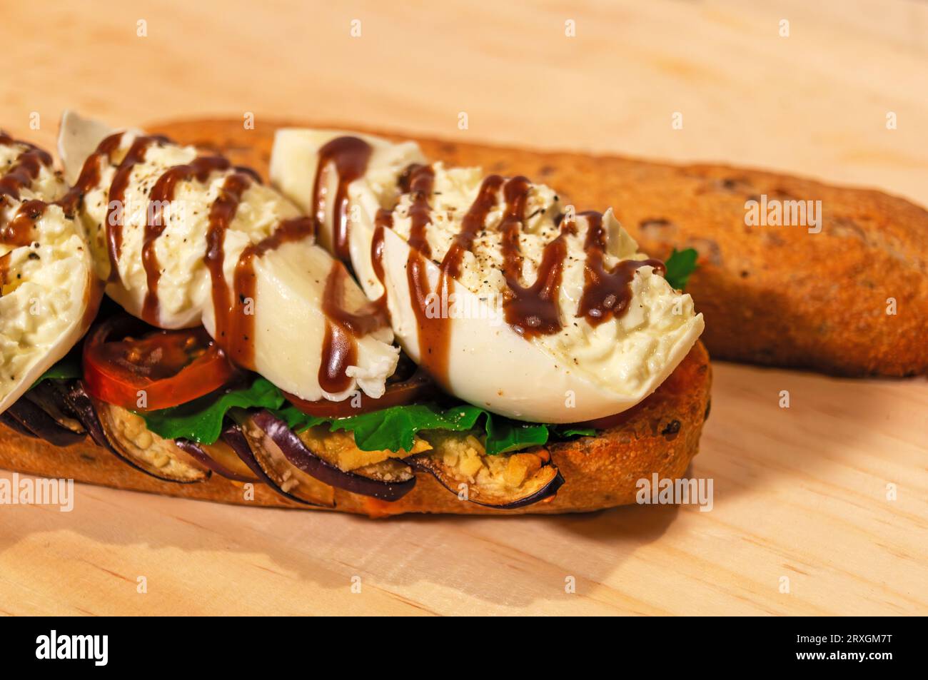 Sandwich of burrata cheese, grilled eggplant, tomato and artisan bread ...