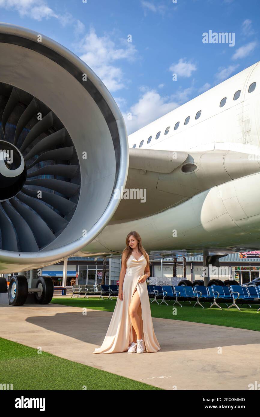 Elegant woman near aircraft, engine, and jet on the runway Stock Photo ...