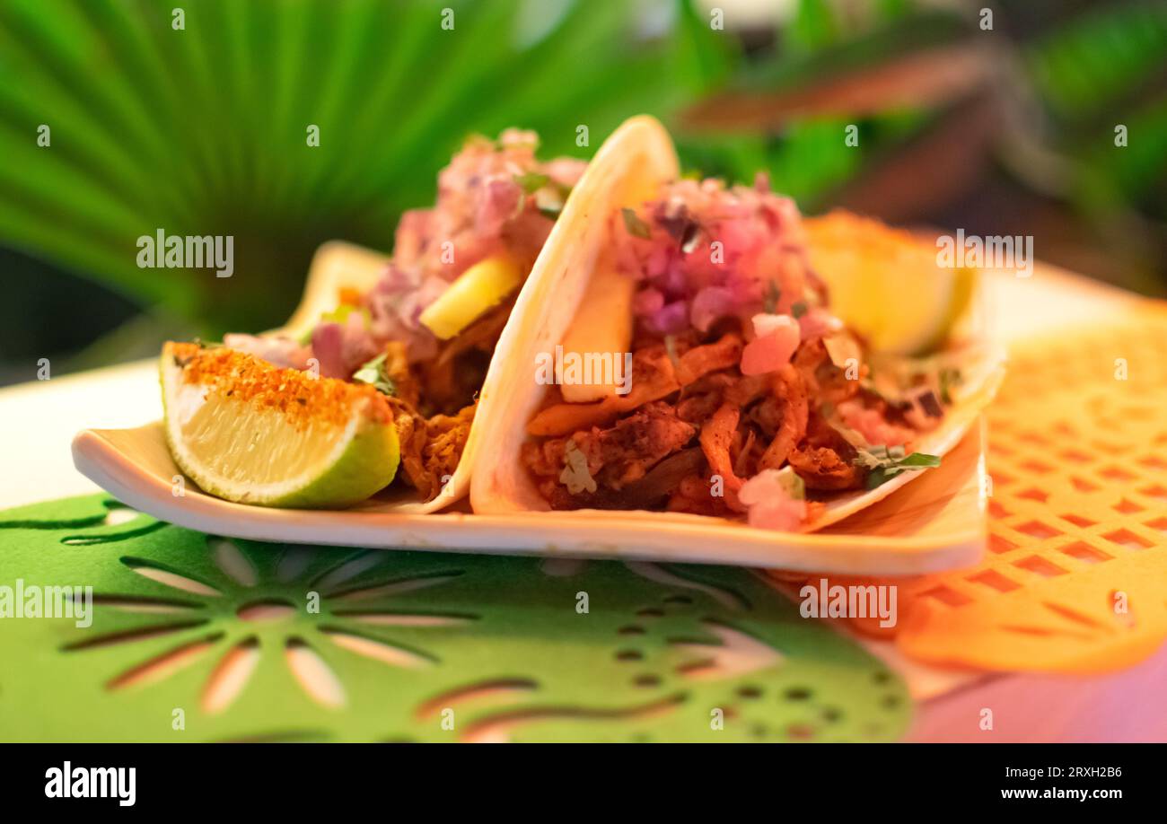Set of Mexican hats of cheerful colors placed in typical stand for ...