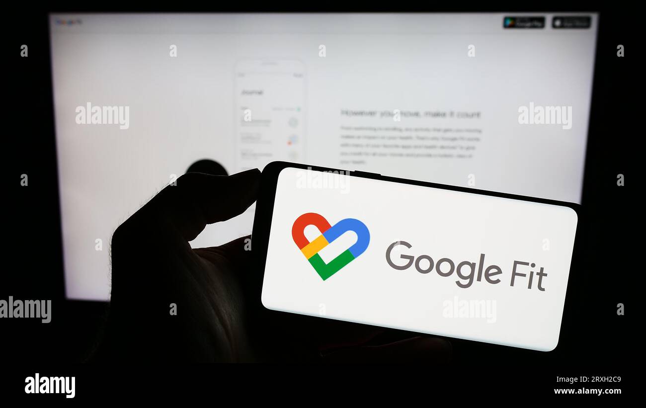 Person holding mobile phone with logo of health-tracking software ...
