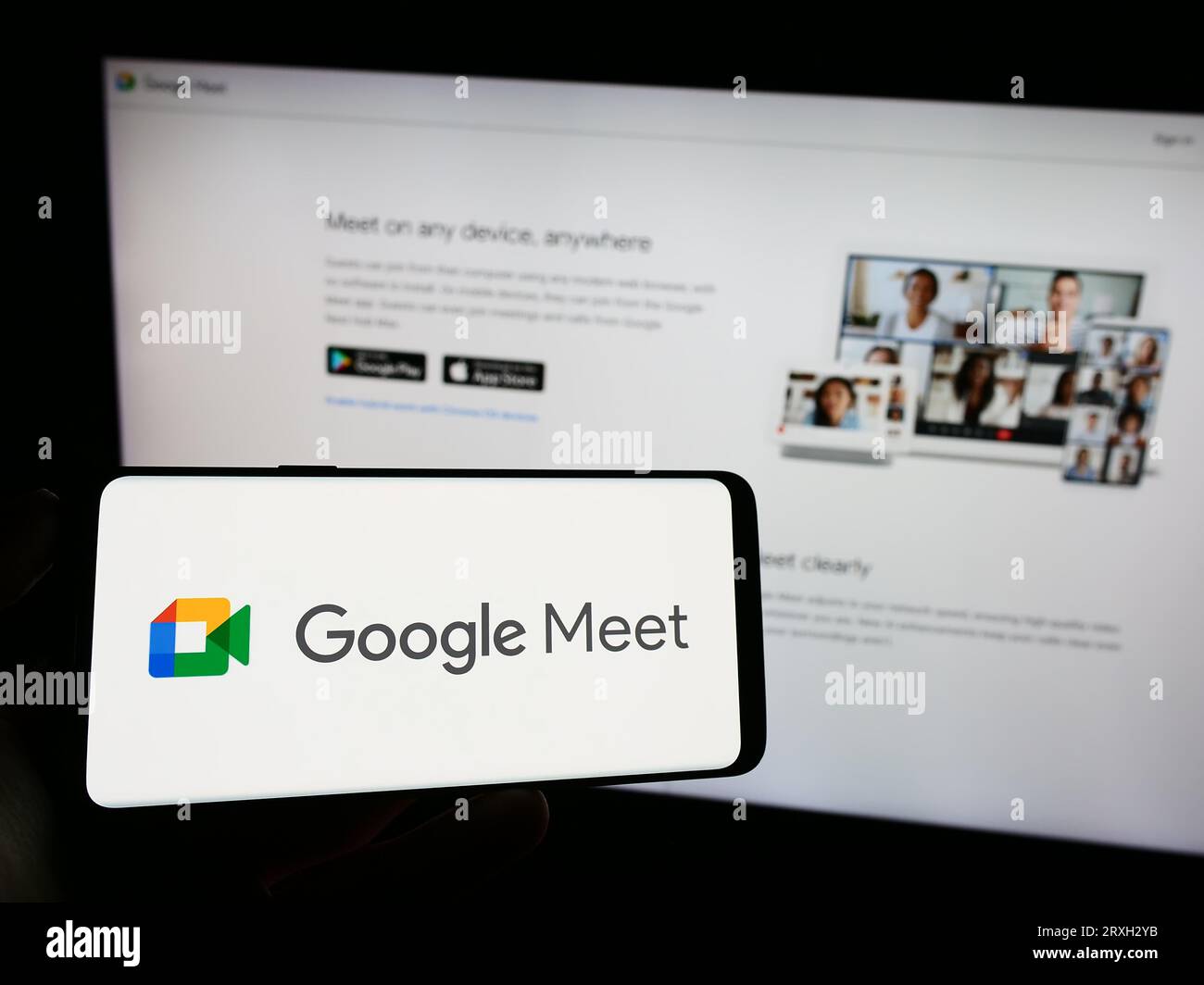 Person holding cellphone with logo of video communication service ...