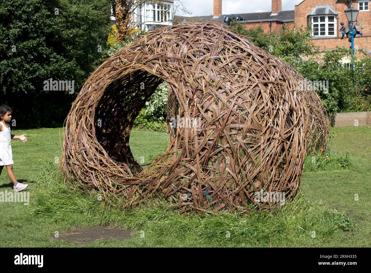 Child walking rtowards Twin woven willow pods built by Forest Edge ...