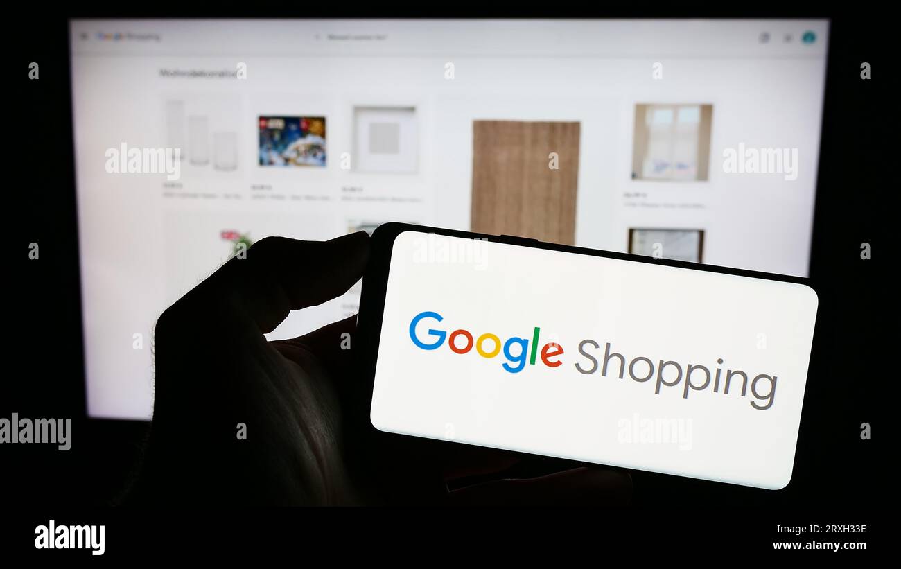 Person holding mobile phone with logo of product search platform Google ...