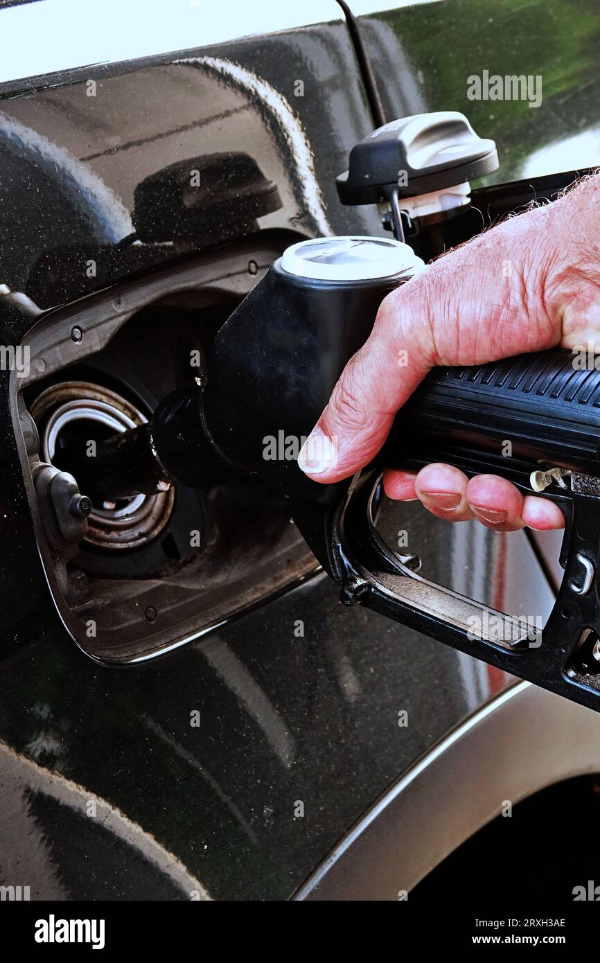 Man fueling his car at a self service petroleum gas station hi-res ...