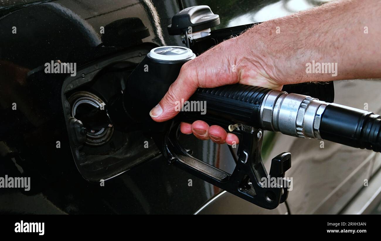 Refueling the car, a man's hand refills diesel fuel at the gas station ...
