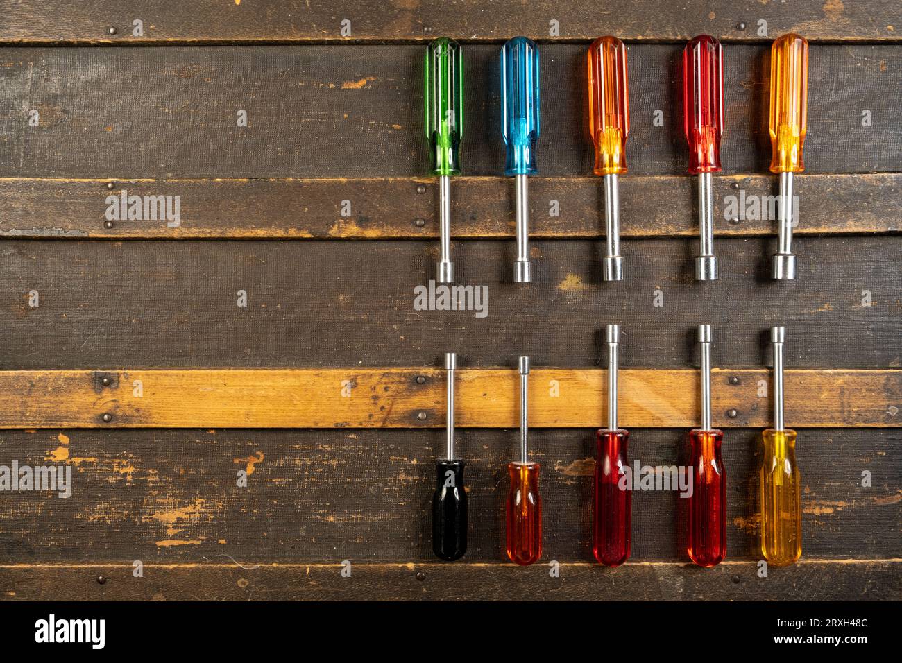 Flat lay of set of nutdriver screwdriver tools with translucent colored ...