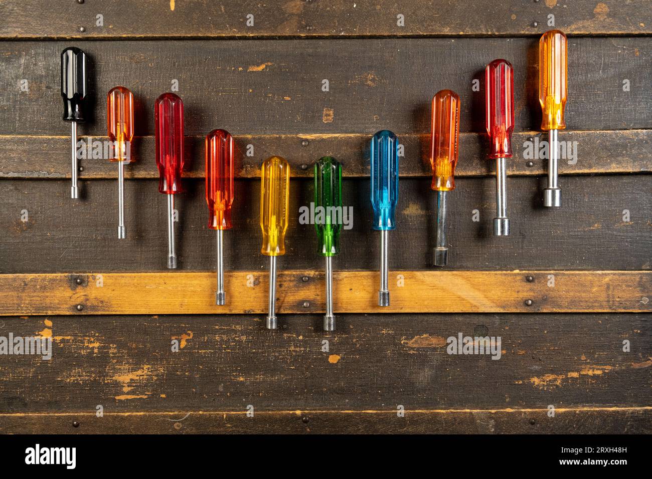 Flat lay of set of nutdriver screwdriver tools with translucent colored ...