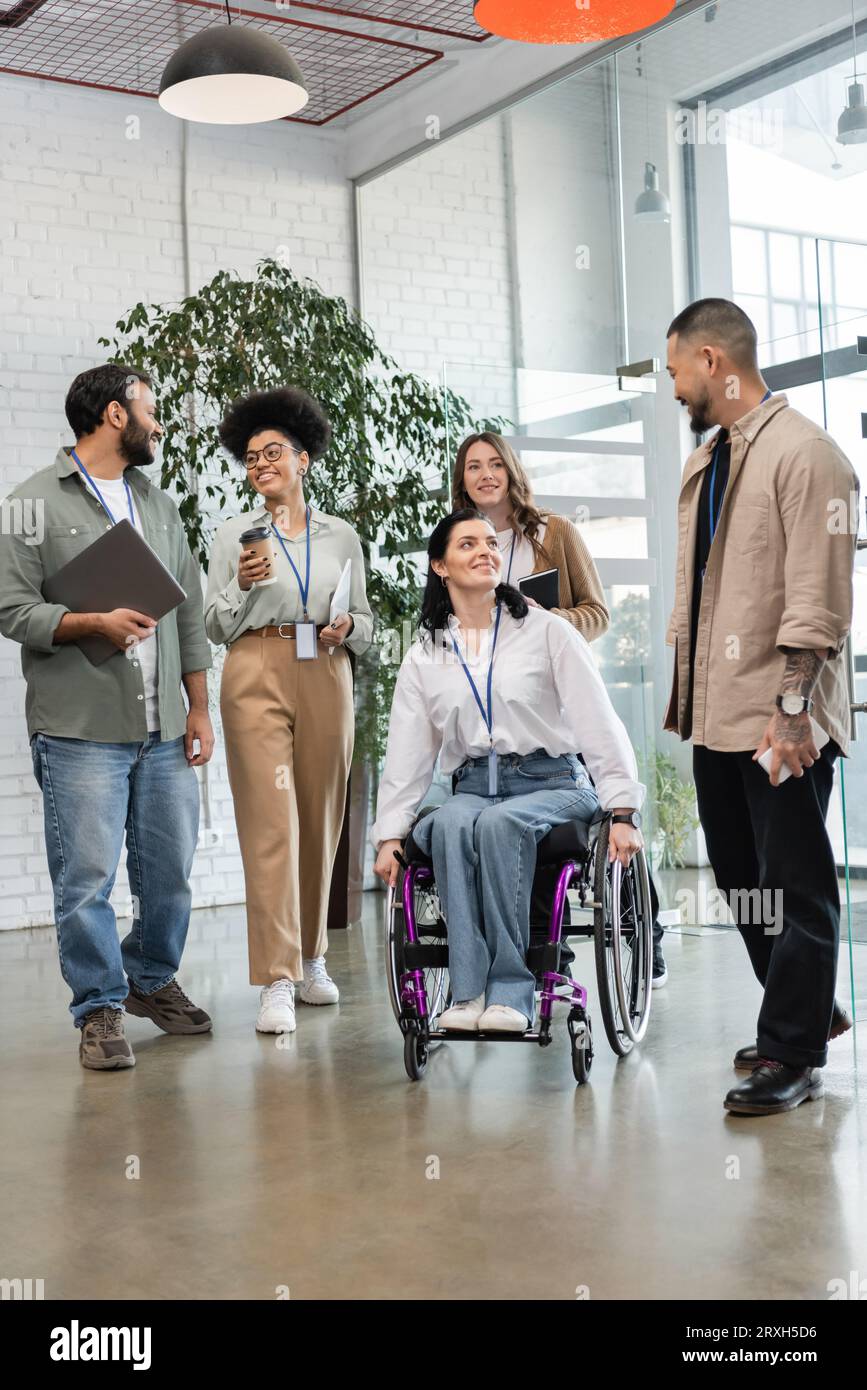 diversity and inclusion, disabled woman in wheelchair looking at asian ...