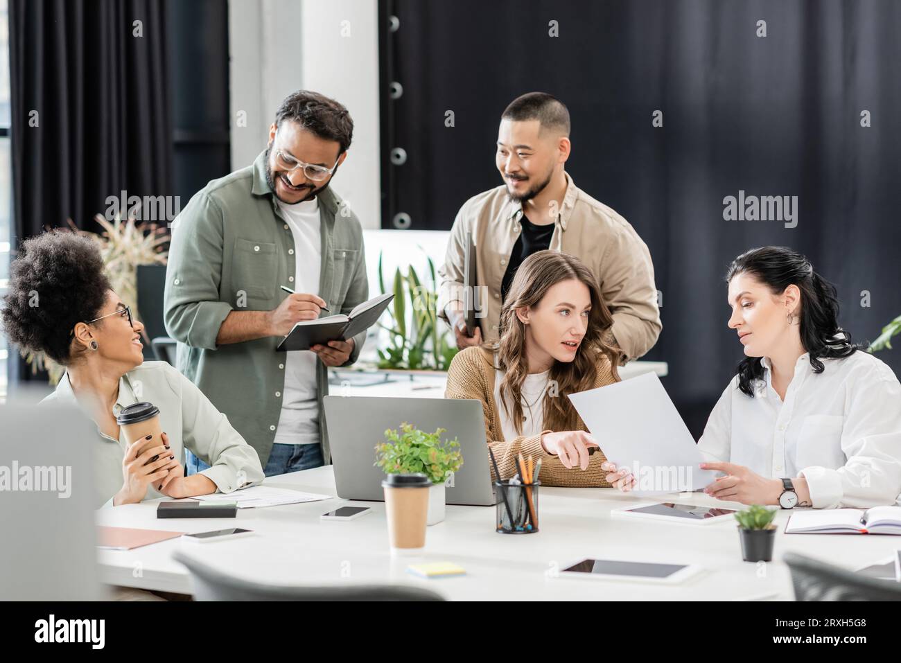 multiethnic business team generating ideas and discussing project in ...