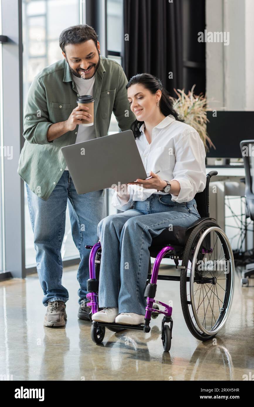 happy indian businessman discussing startup project with disabled woman ...