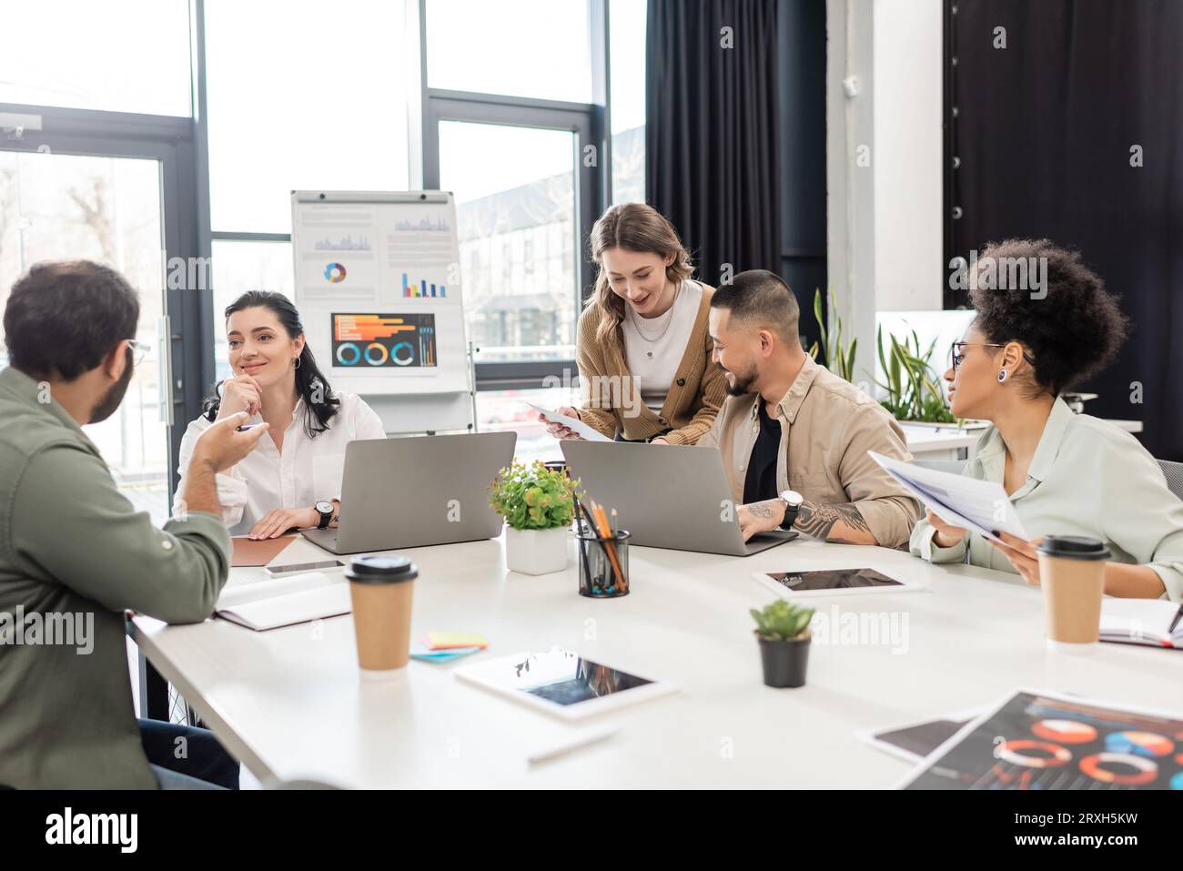 happy team lead listening ideas of indian coworker near multicultural ...