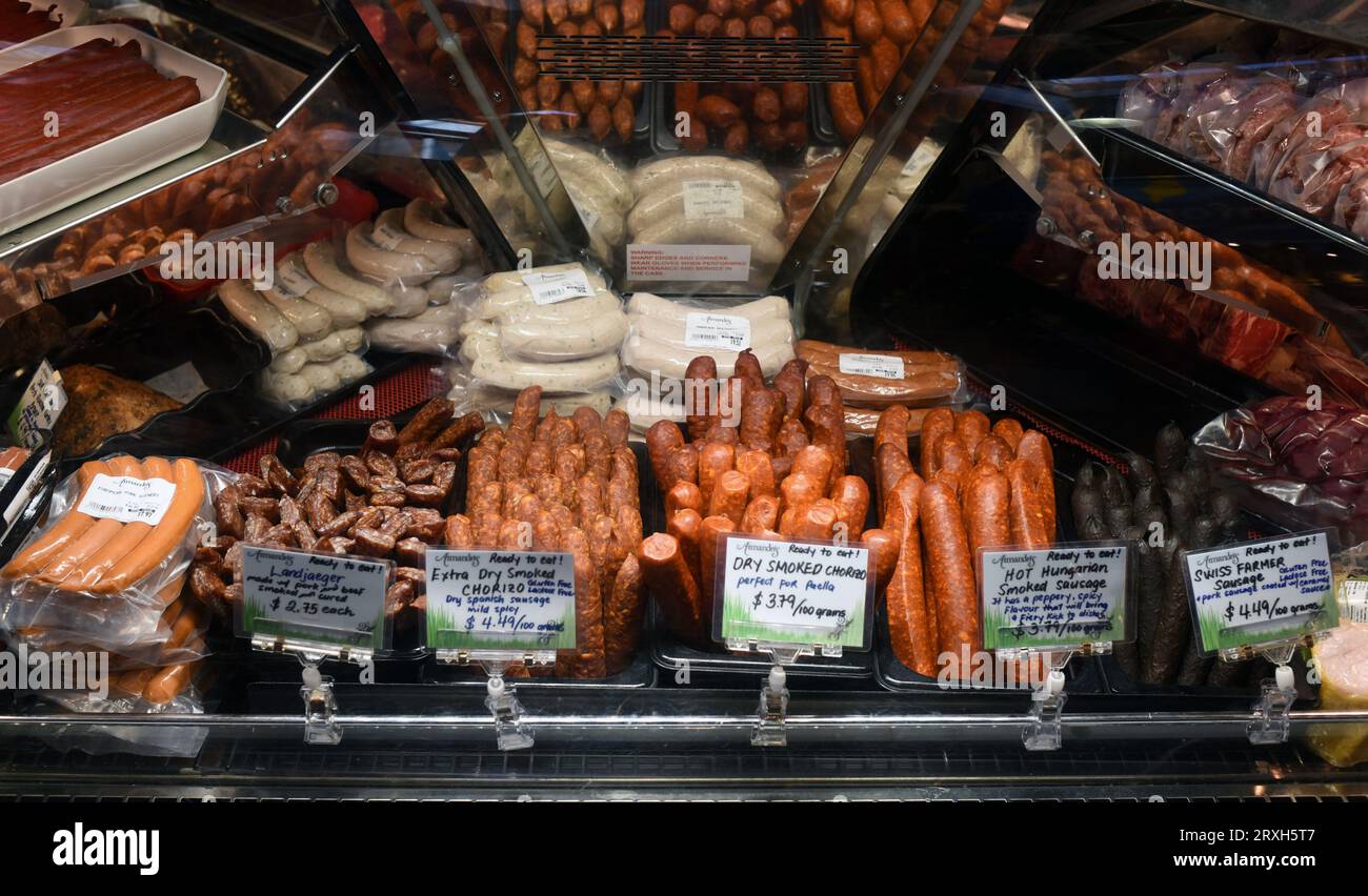 A variety of sausages are pictured for sale in a glass display case at ...