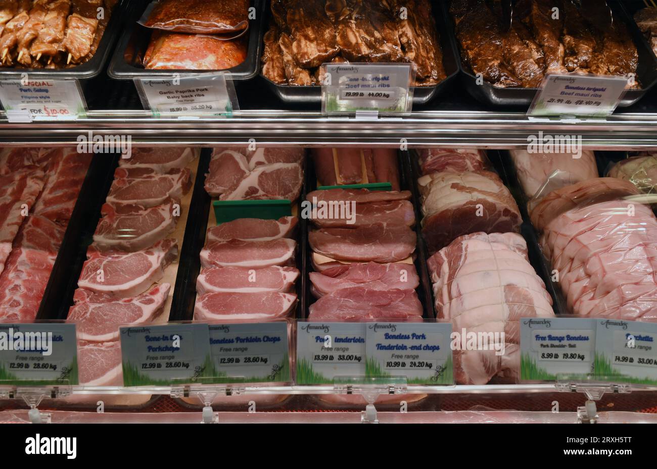 A variety of meat products including pork are pictured for sale in a ...