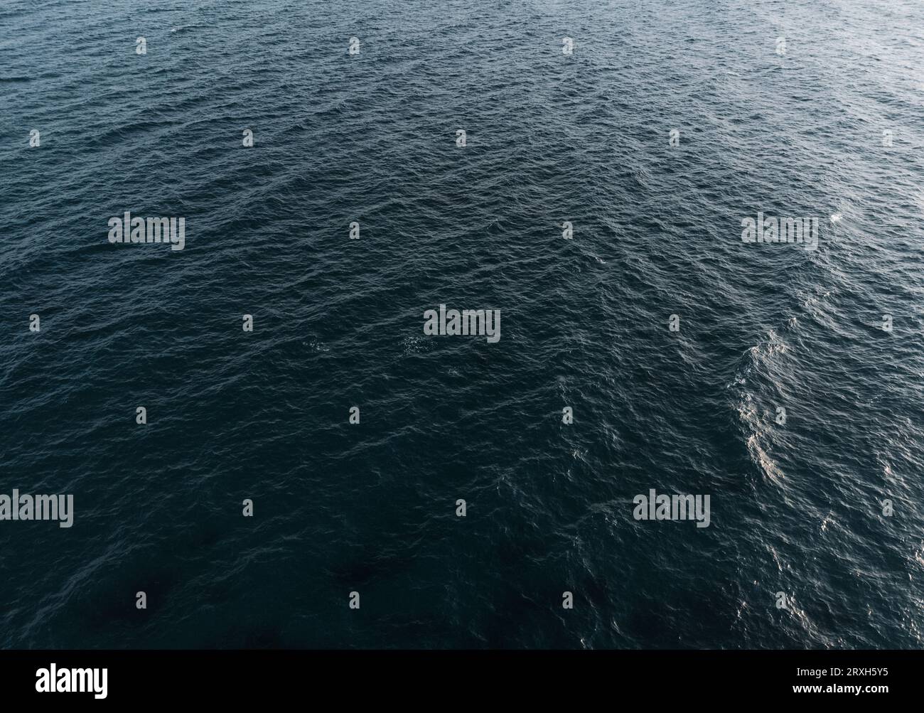 Image of a calm and peaceful blue ocean surface with small waves. Dark ...