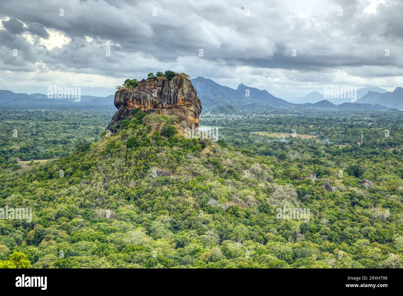 Ancient rock, green landscape with blue sky and clouds Stock Photo - Alamy