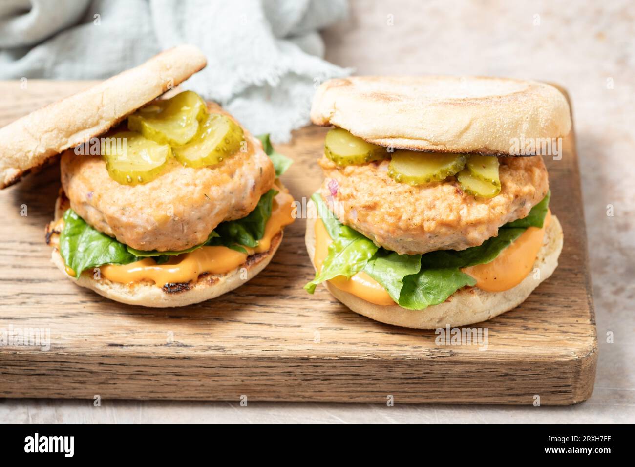 Salmon fishburger english muffin sandwich Stock Photo - Alamy