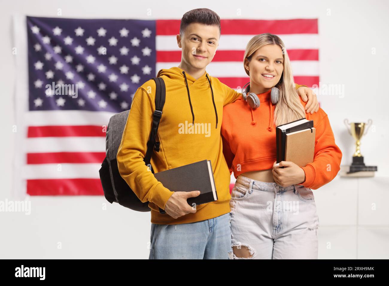 Students with backpacks and books standing in front of a USA flag Stock ...