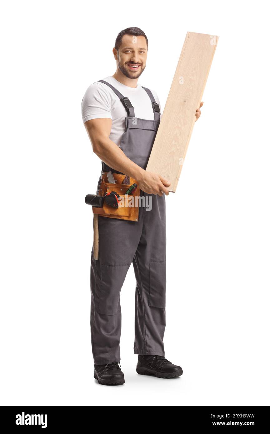 Full length portrait of a carpenter holding a wooden floor beam ...