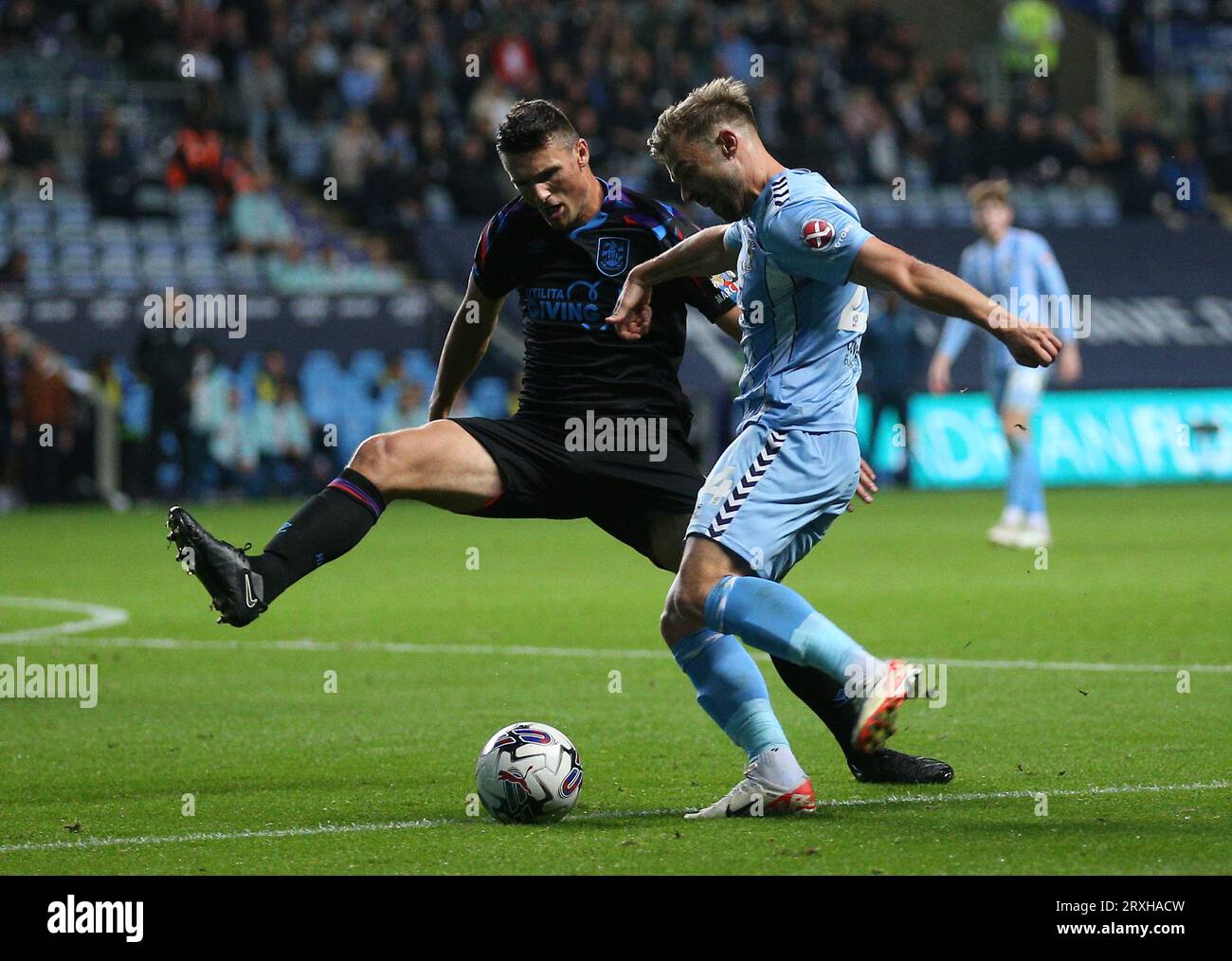Huddersfield Town's Matty Pearson (left) tries to close down Coventry ...