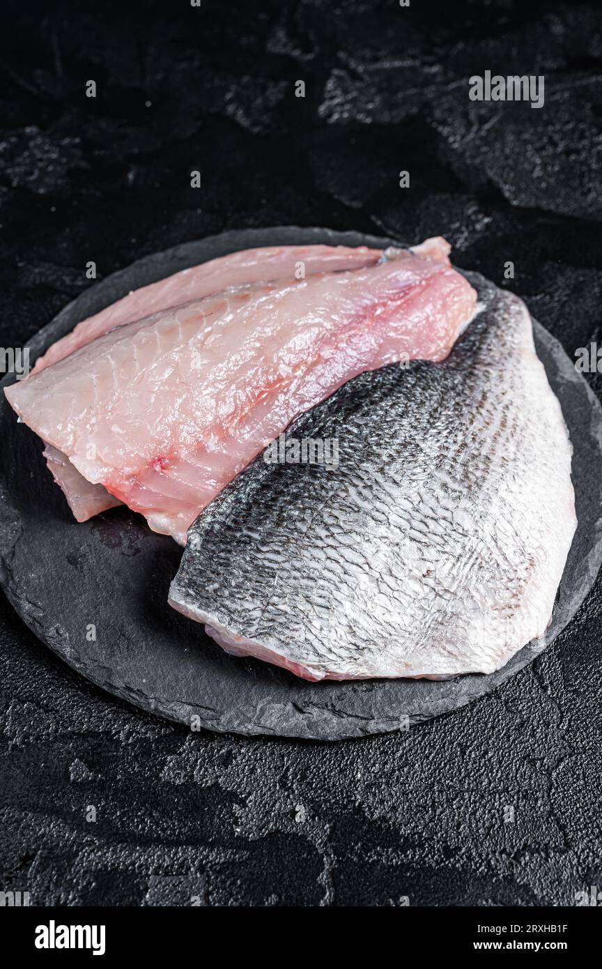 Raw Sea bream Dorado fish fillets. Black background. Top view Stock ...