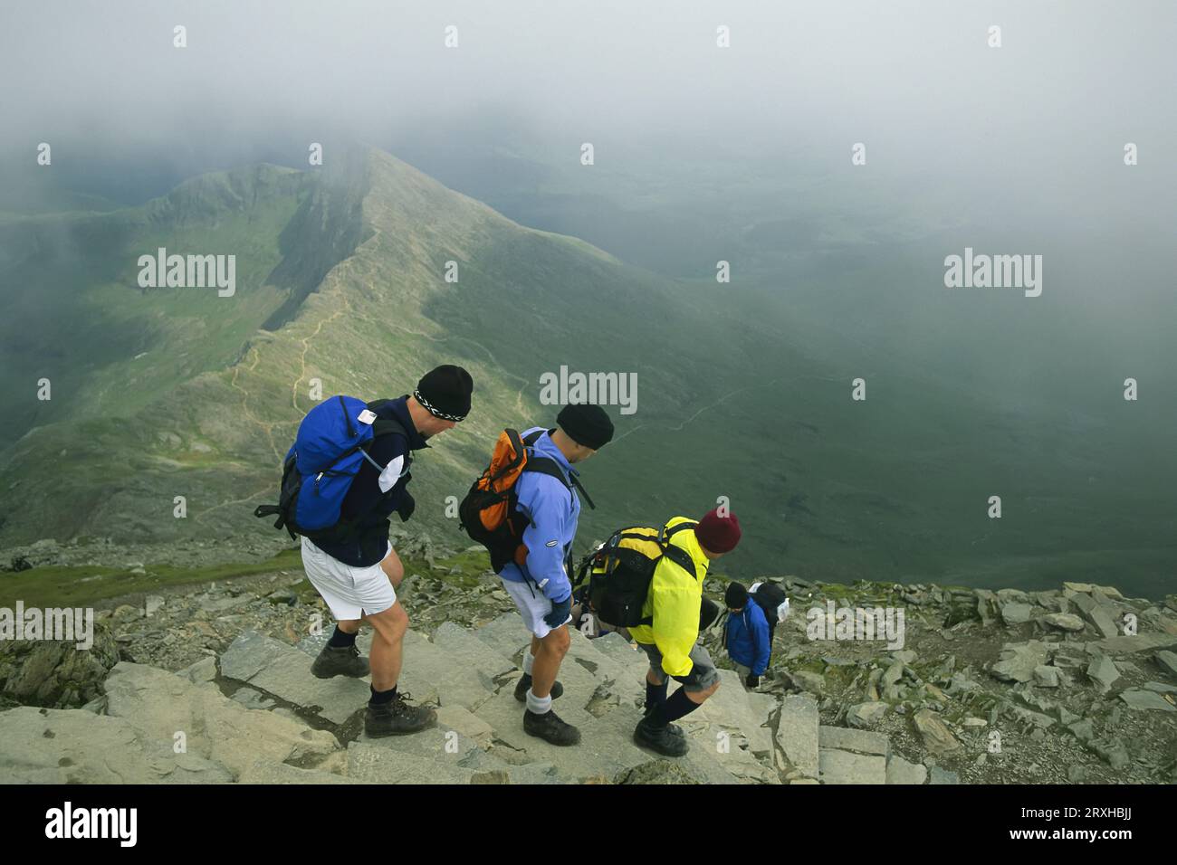 Hikers descend stone steps high atop Mount Snowdon in Wales; Wales ...