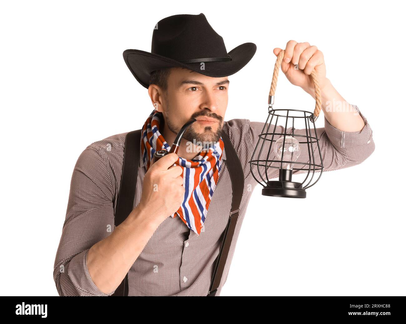 Handsome cowboy with lantern and smoking pipe on white background Stock ...