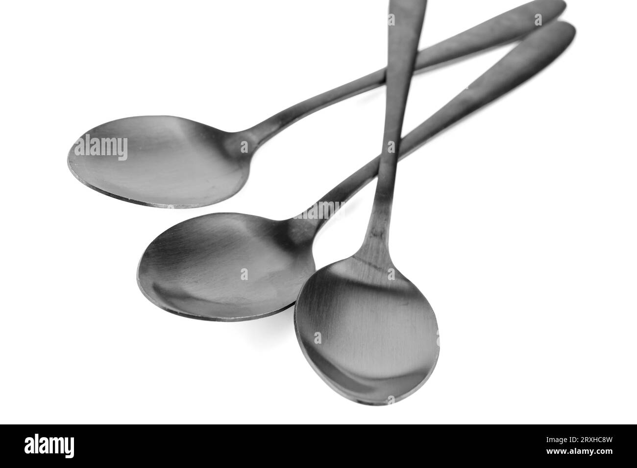 Stainless steel spoons on white background Stock Photo - Alamy