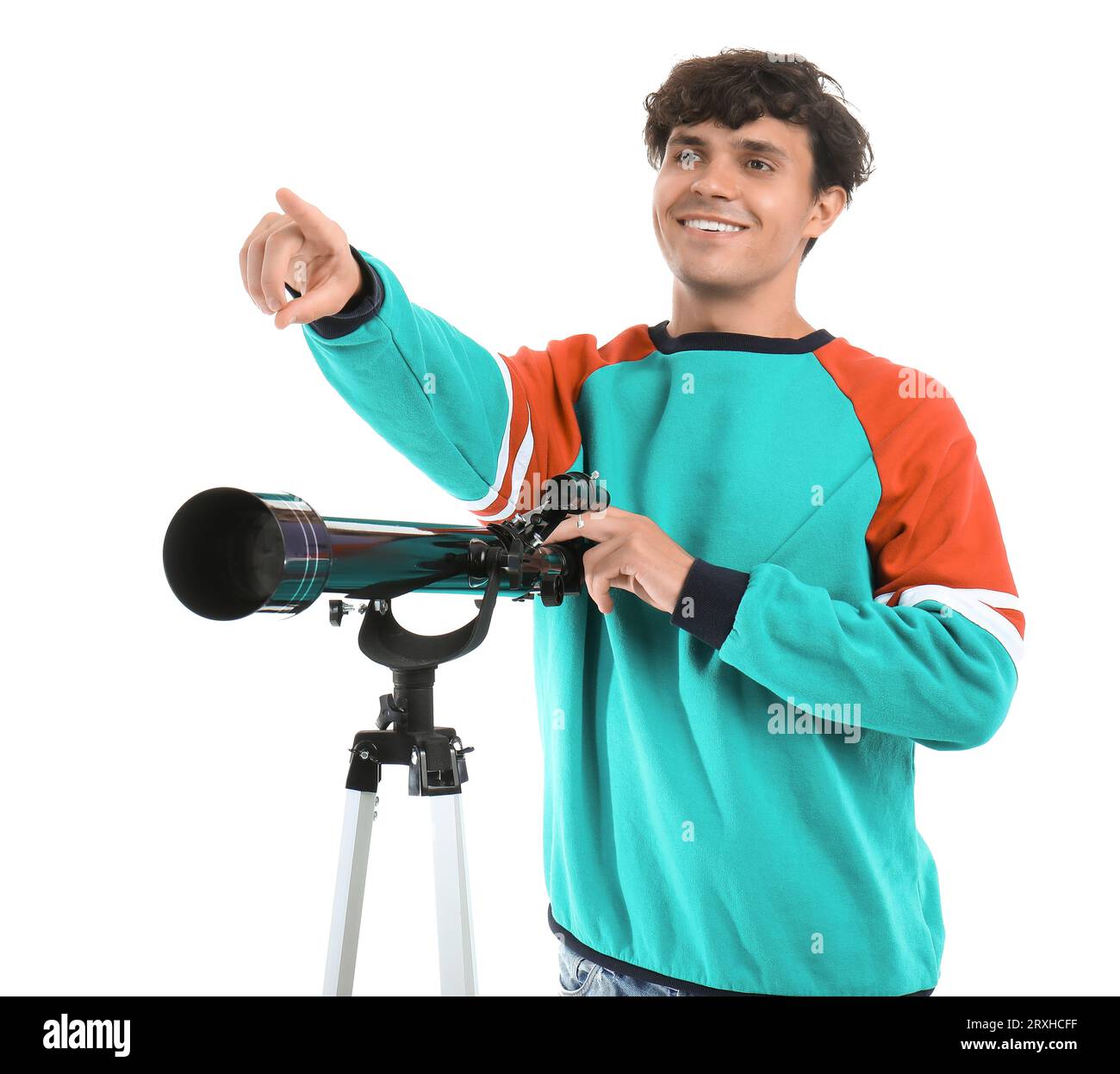 Young man with telescope pointing at something on white background ...