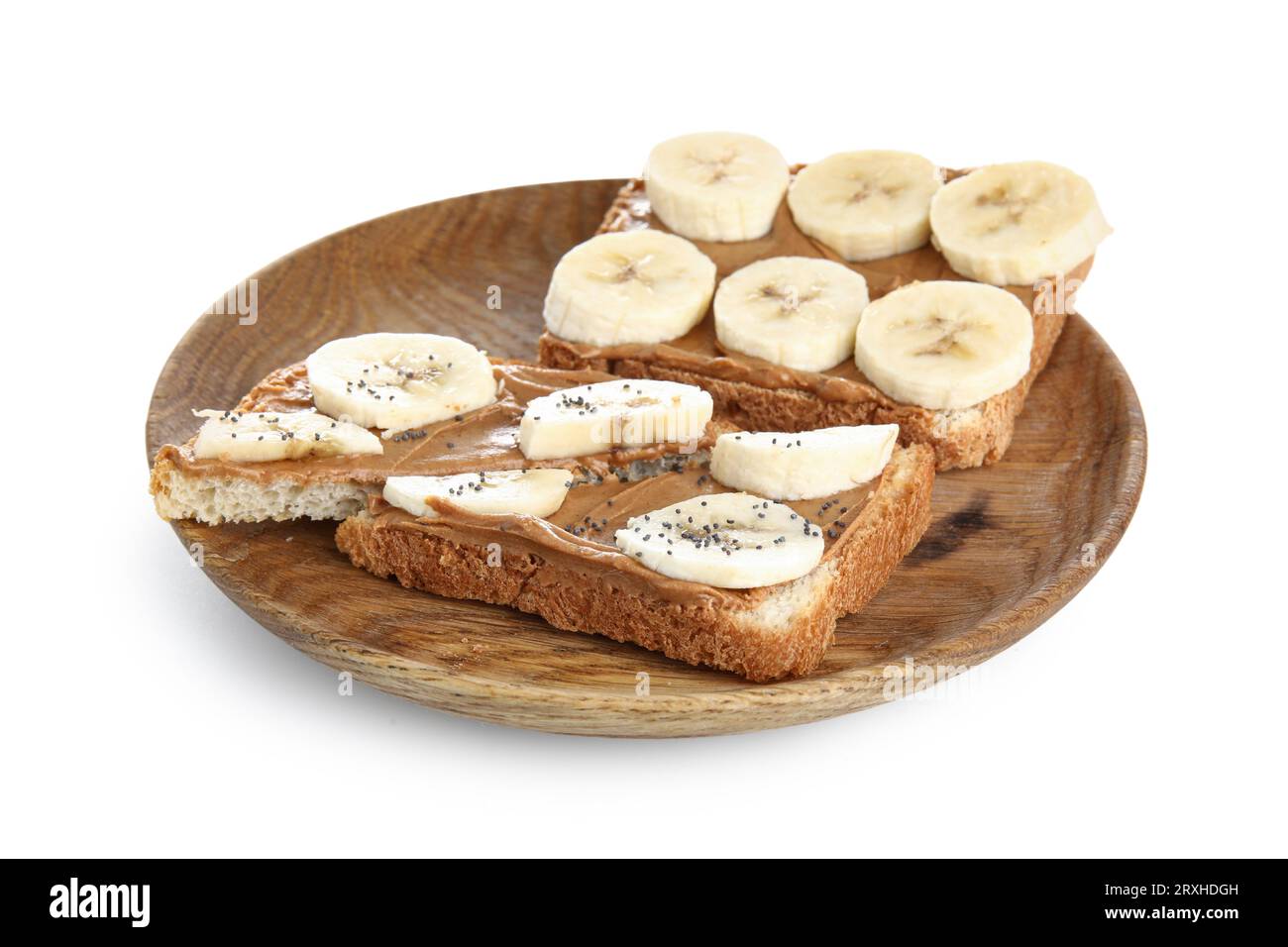 Wooden plate of toasts with peanut butter and banana on white ...