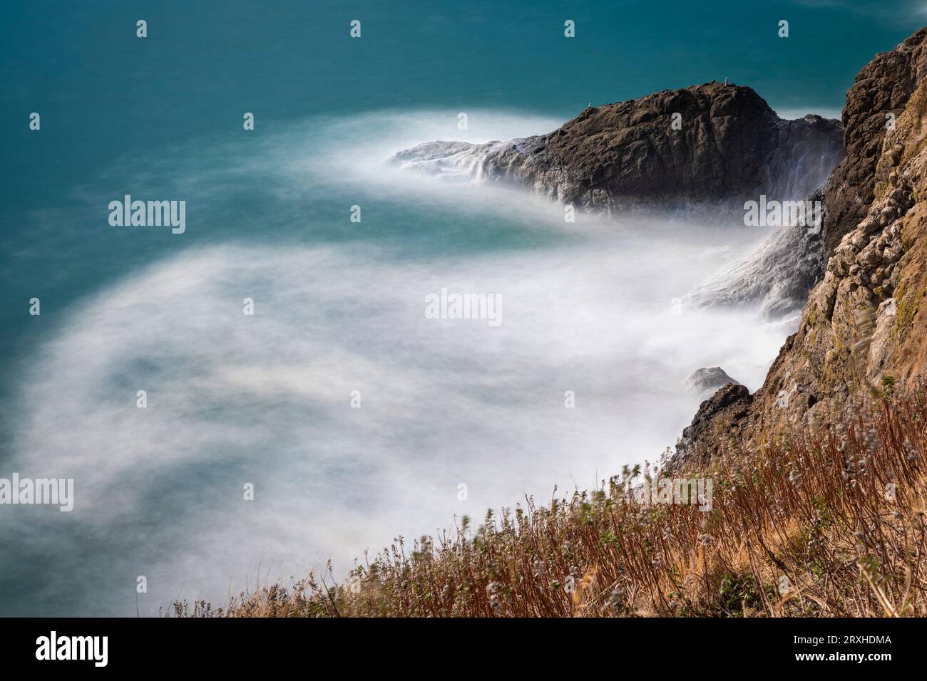 Long exposure of frothy waves crashing into the cliffs at Cape ...