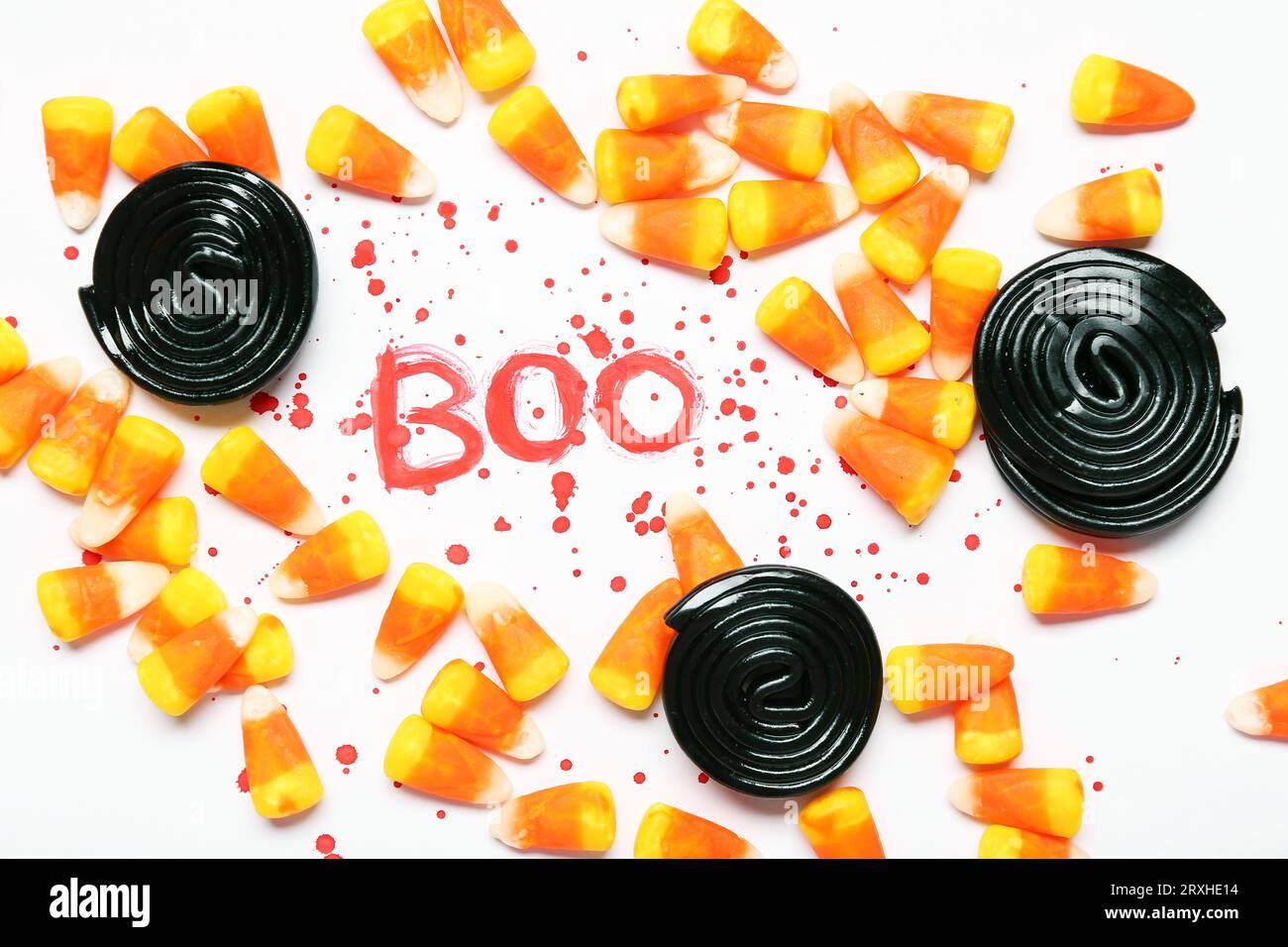 Halloween composition with licorice candies, candy corns and word BOO ...