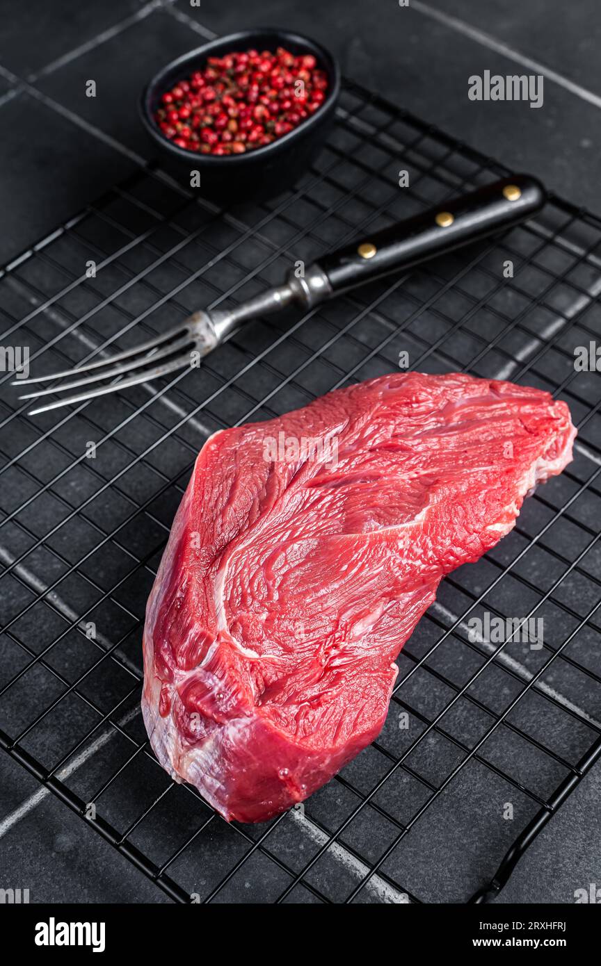 Raw beef meat piece for grilling with spices. Black background. Top ...